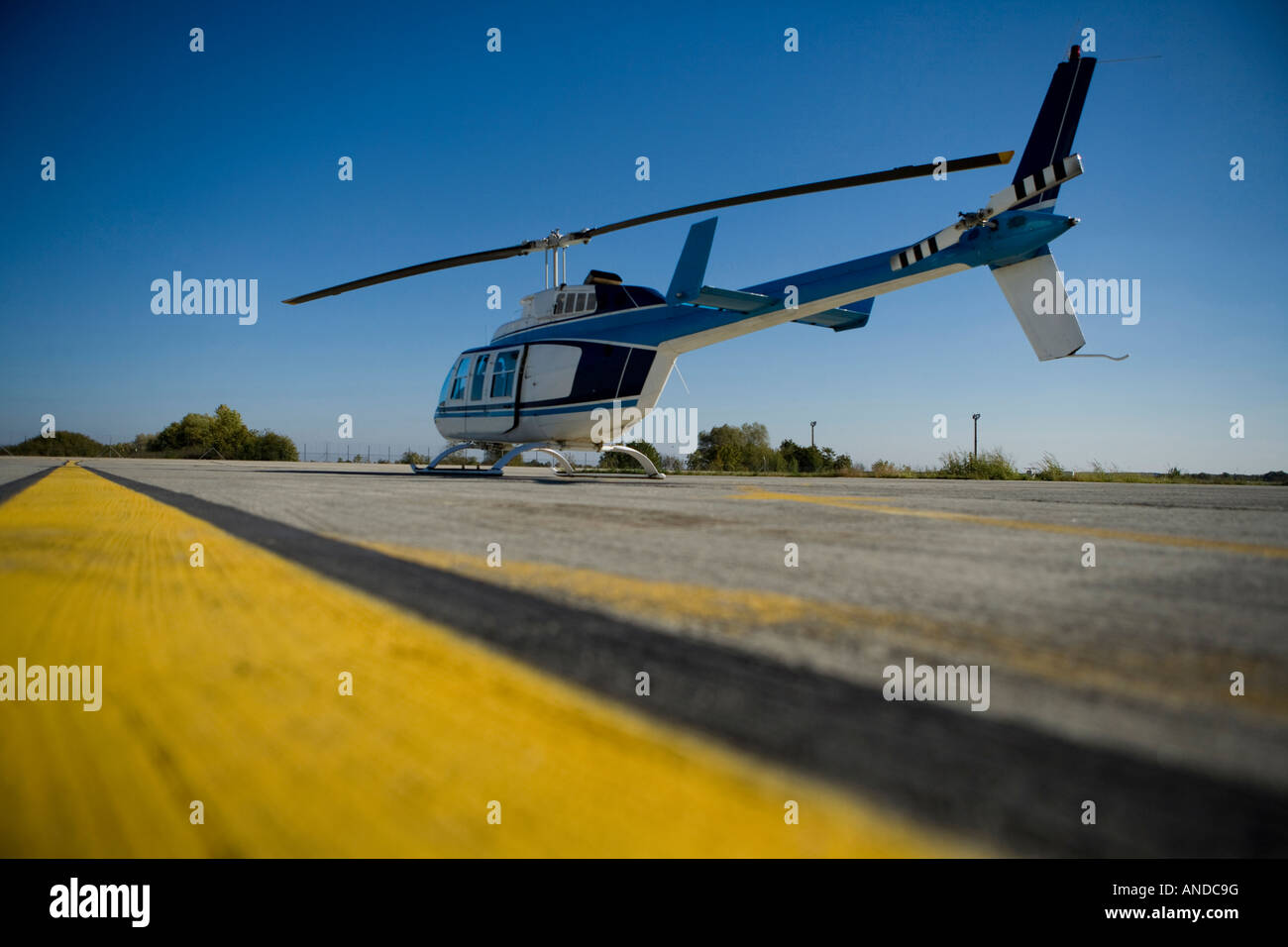 yellow line mark on landing track with an helicopter Stock Photo - Alamy