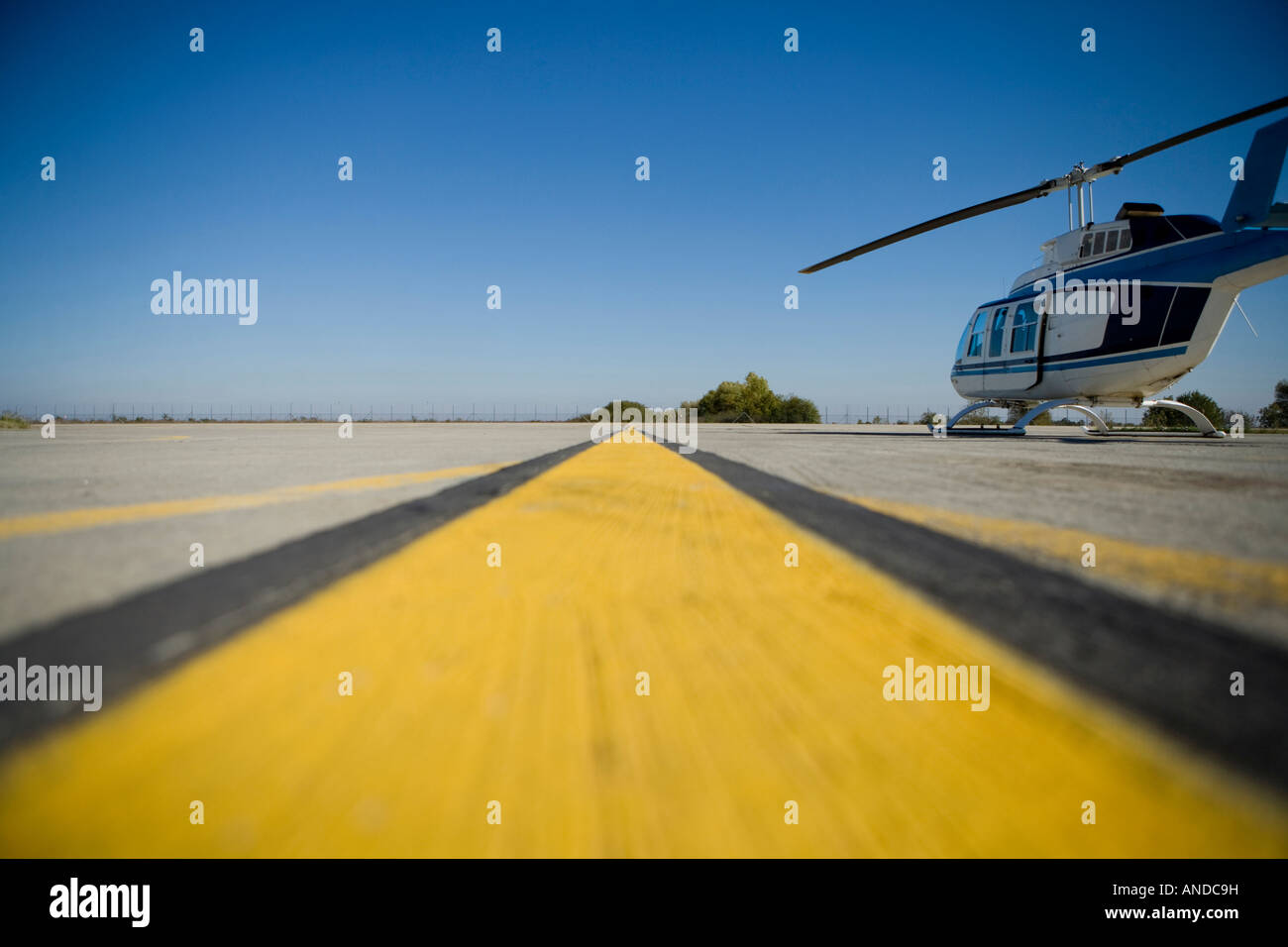 yellow line mark on landing track with an helicopter near Stock Photo ...