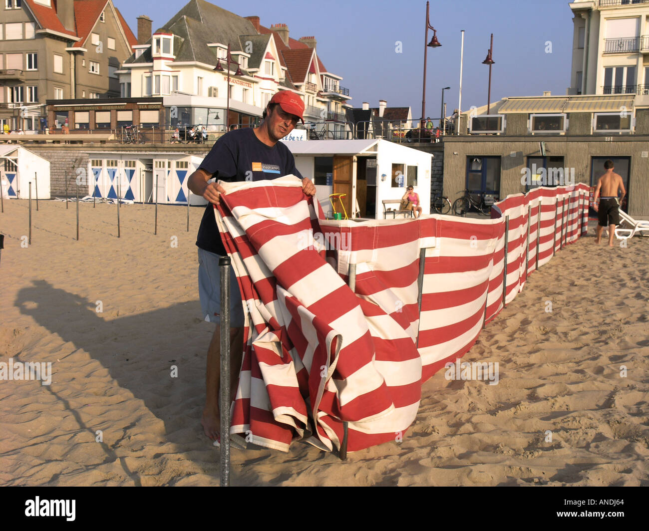 Belgium Oostende Ostend Ostende beach swim Man folding wind block at ...