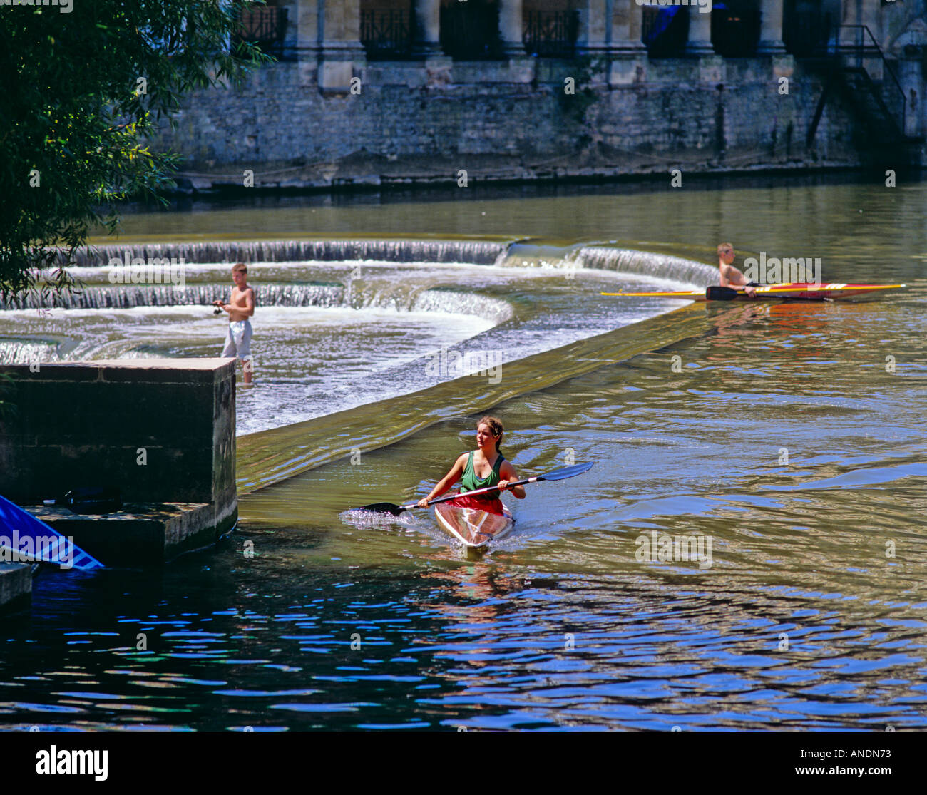 People enjoy summer on the river Avon by the Pulteney Bridge in Bath ...