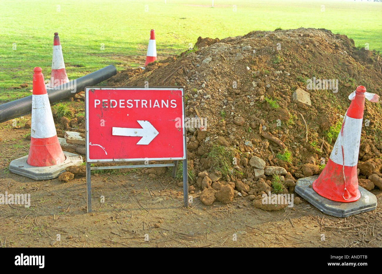 road sign inviting pedestrians to walk into a pile of mud Stock Photo ...