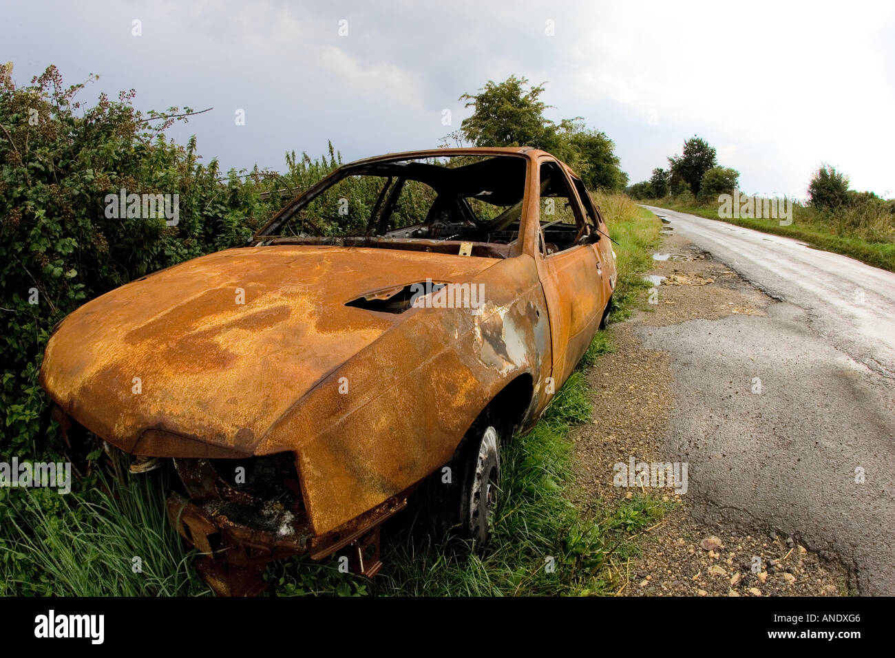 Burnt out car wreck on roadside Oxfordshire United Kingdom Stock Photo ...