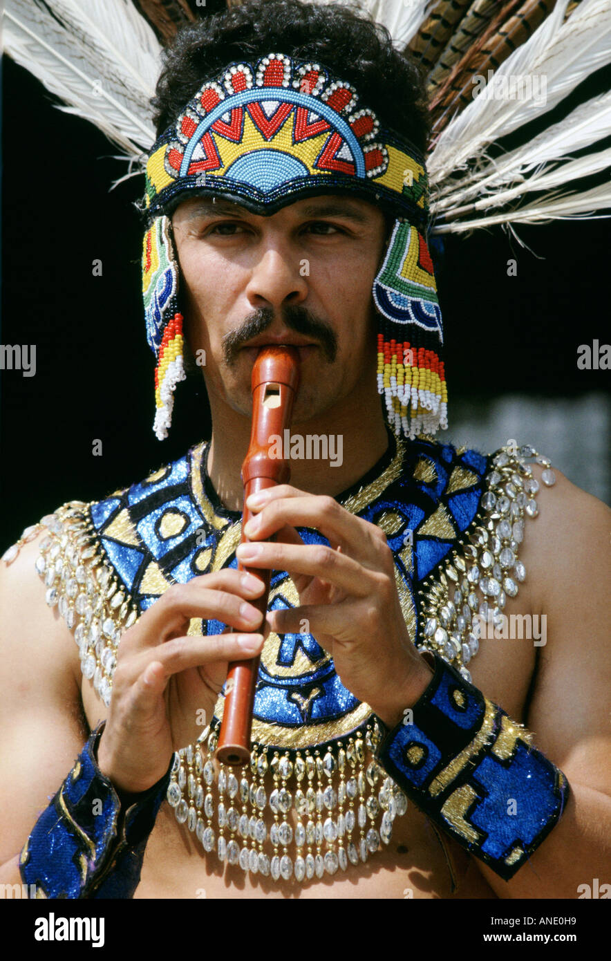 Man in Mexican Aztec Indian outfit plays recorder United States of ...