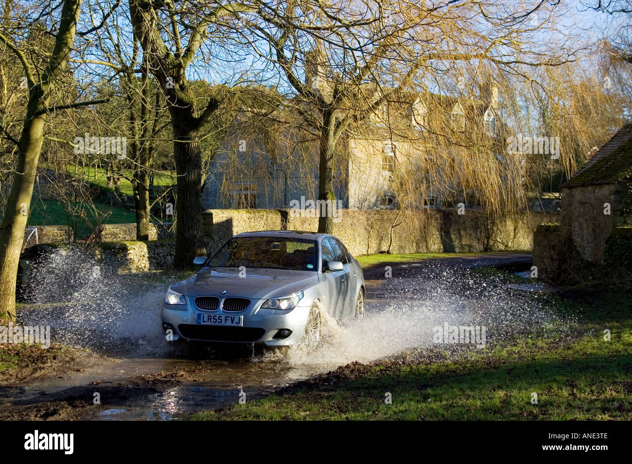 Motorists drive through flood water hi-res stock photography and images ...