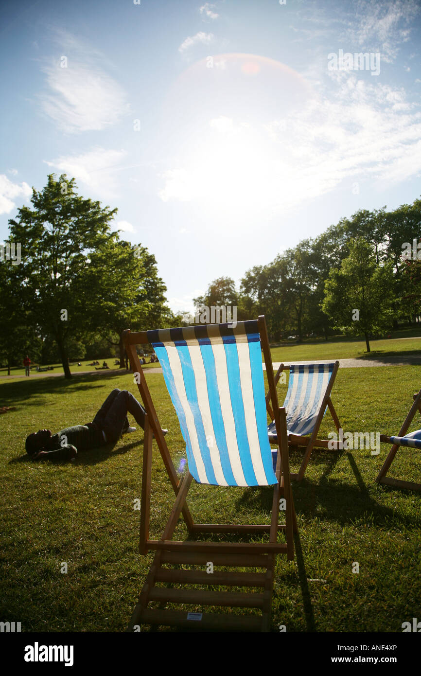 Man relaxing asleep sun worship lying deckchair blue white black summer ...