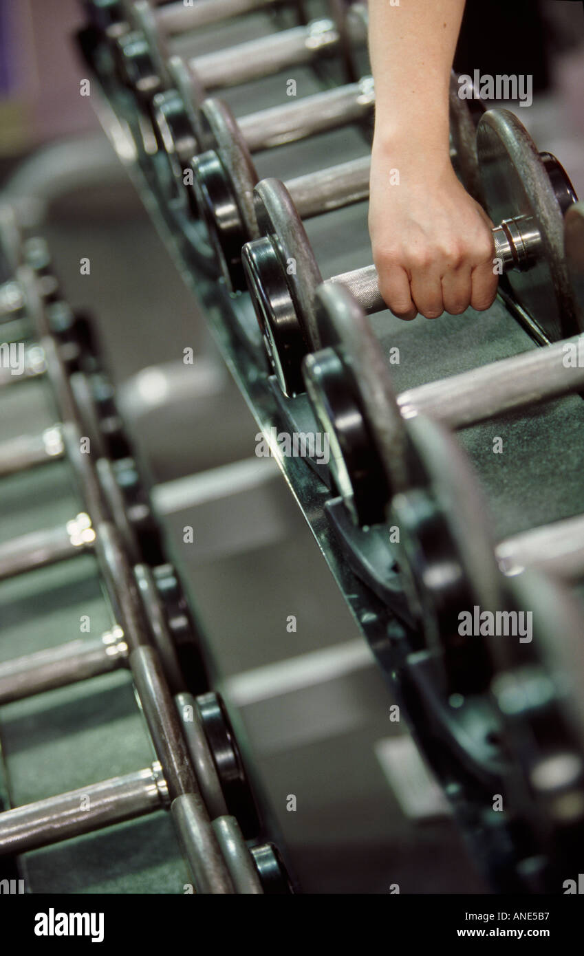 hand grabbing a dumbell from rack Stock Photo - Alamy