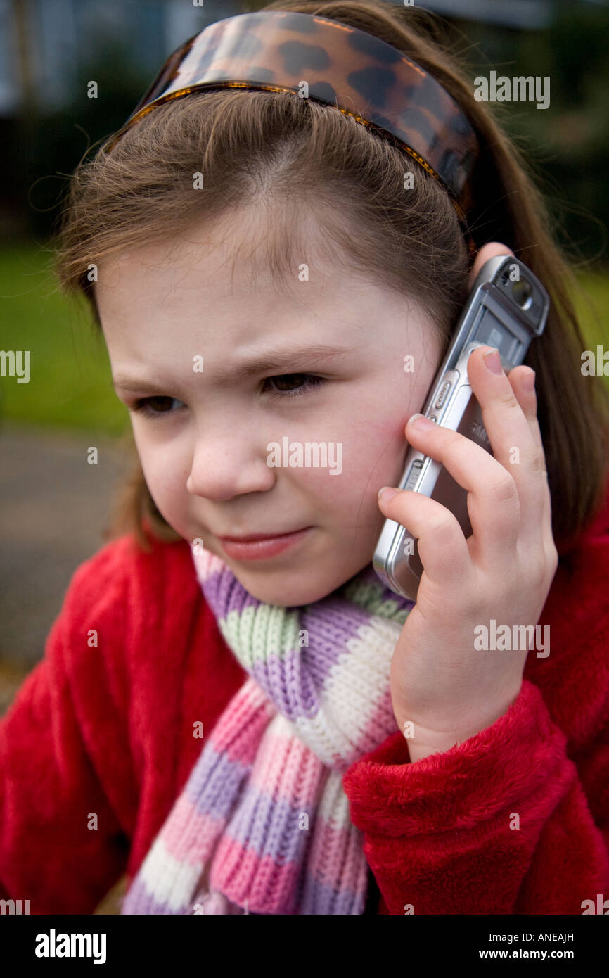 Young concerned girl on bike talking on mobile phone Stock Photo - Alamy
