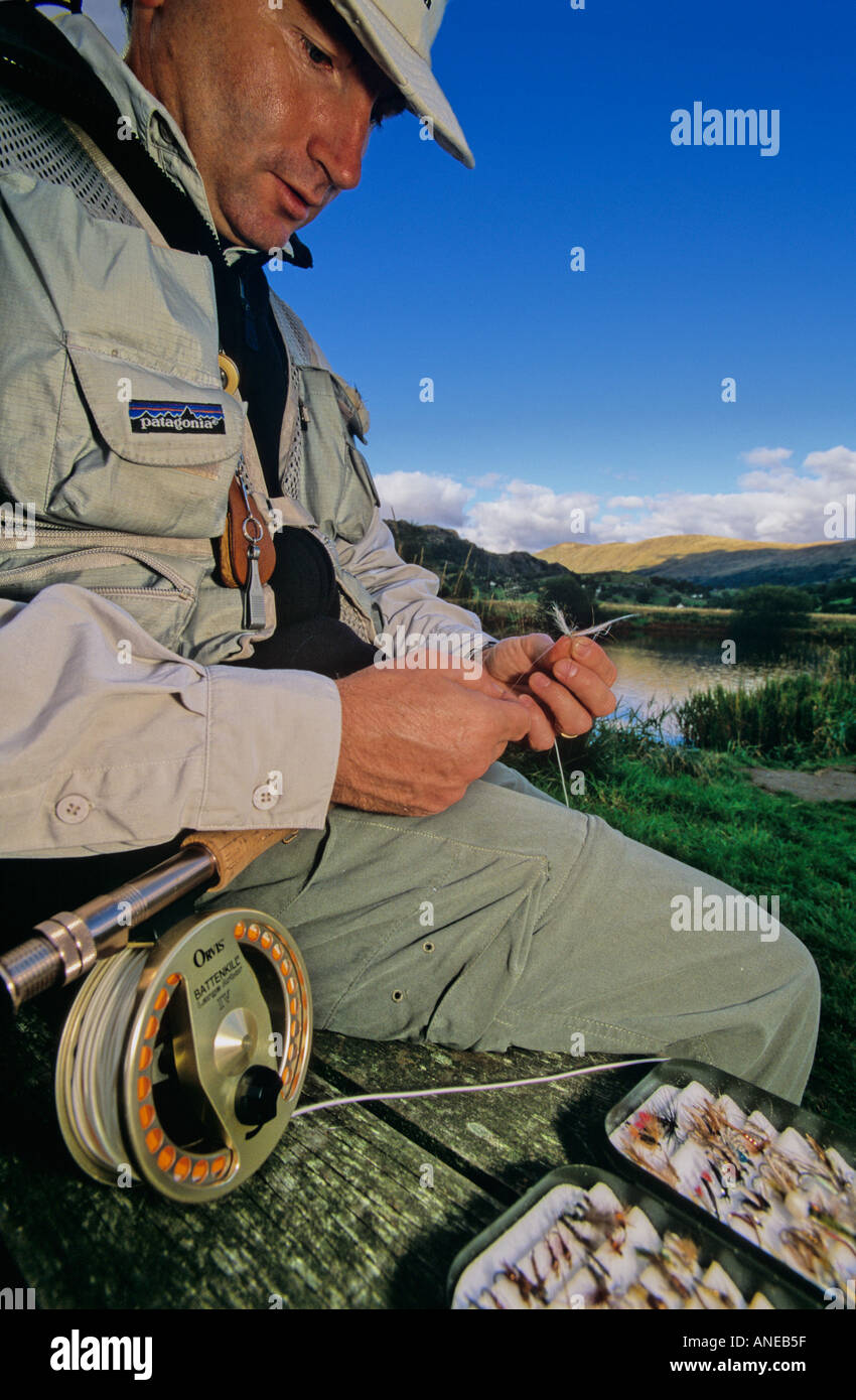 fly fisherman tying on fly Stock Photo - Alamy
