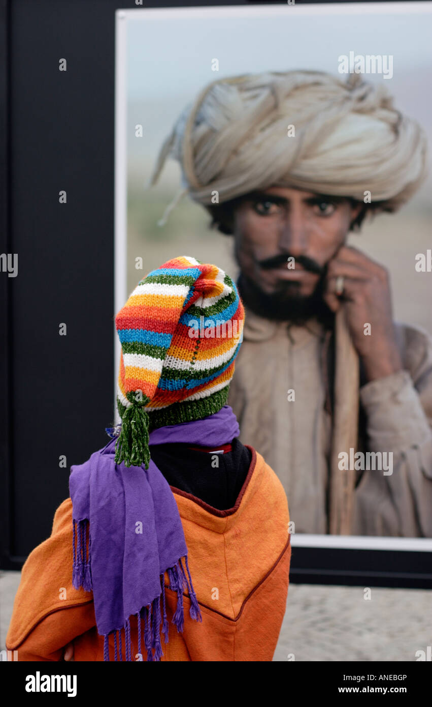 Young woman spectator at an outdoor exhibition of photographs by Steve ...