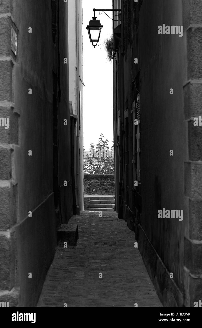 Cobblestone alley with hanging gas light in a medieval French ...