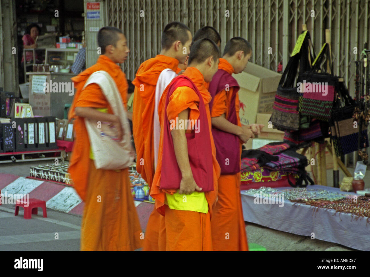 Group of young shaved head novices colourful robe walk go together ...