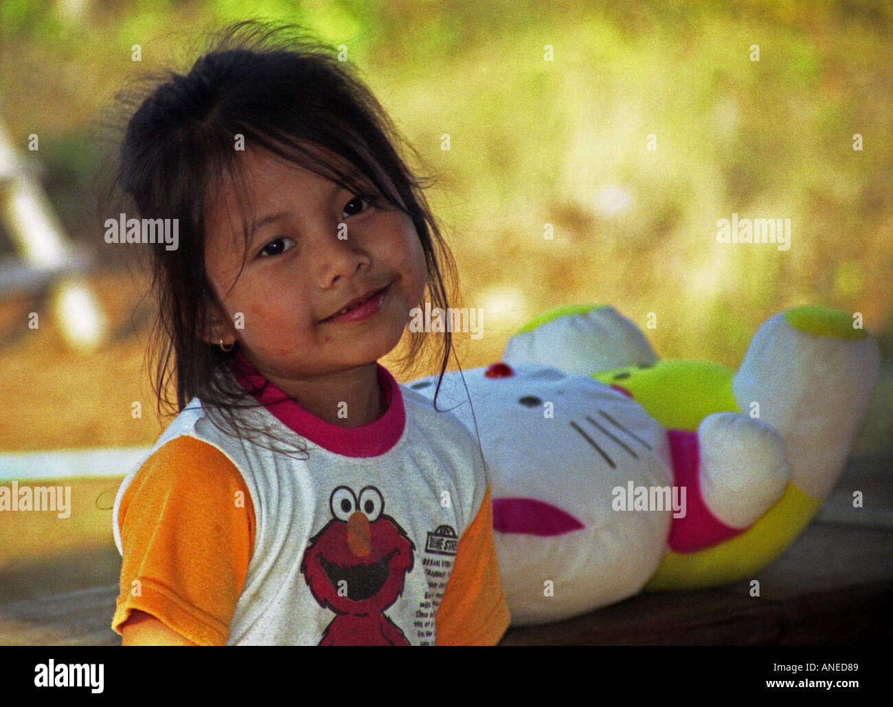 Little colourful happy indigenous child girl play outdoor with hello ...