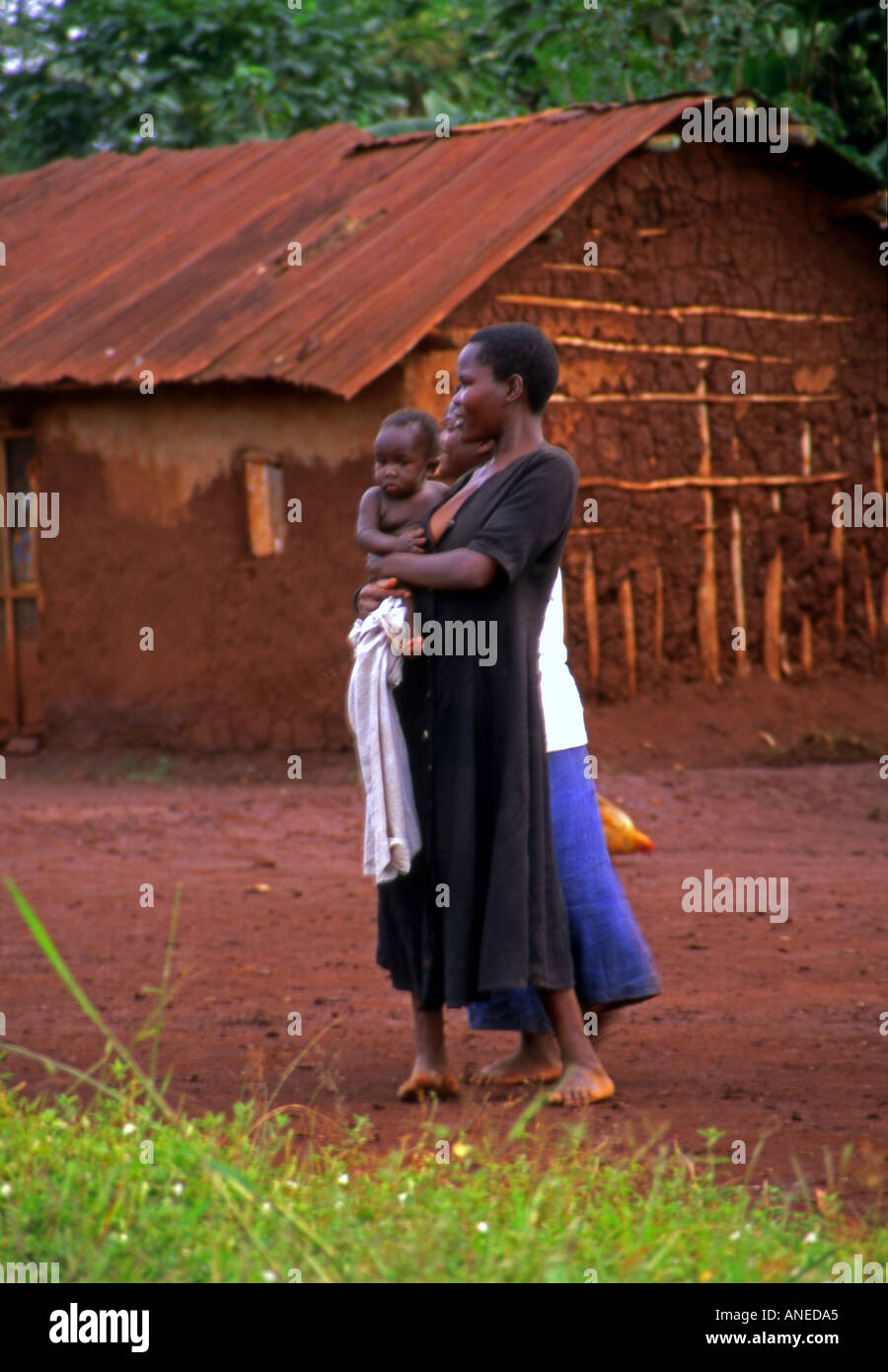 Portrait indigenous woman poor rural village outdoor hold look baby boy ...