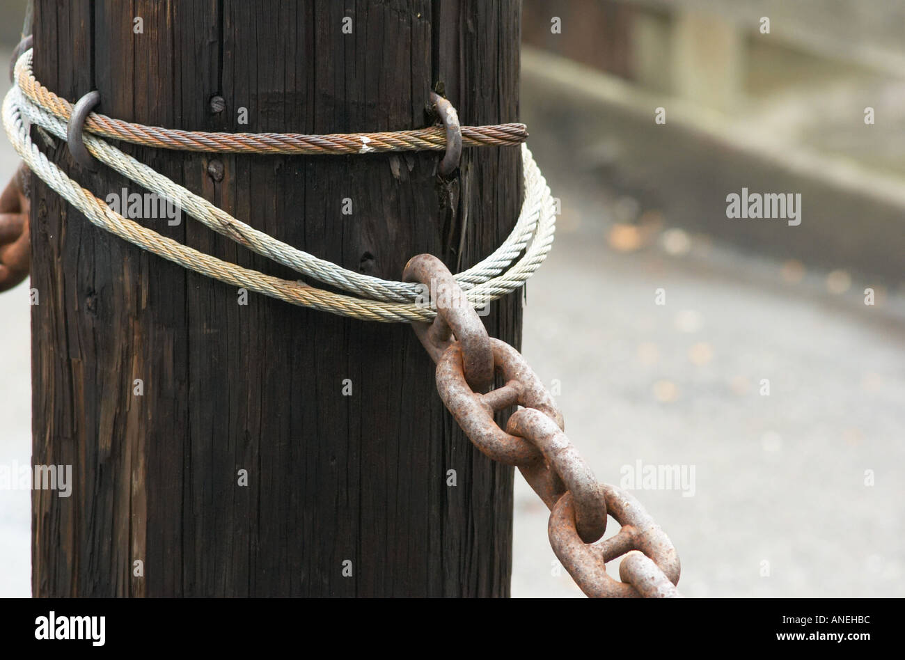 Pier piling with cable and chain Stock Photo - Alamy