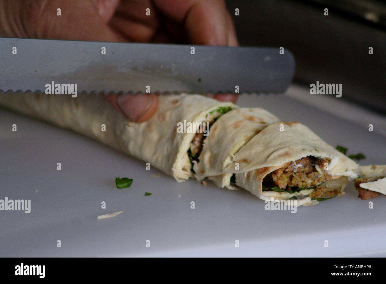 Knife Slicing a Persian Wrap Stock Photo - Alamy