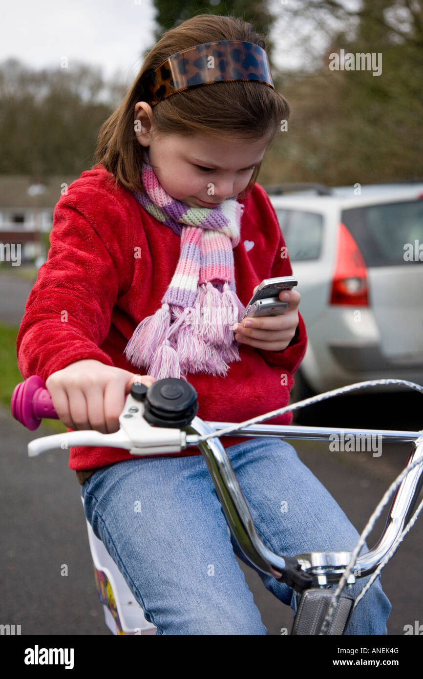 Young concerned girl texting or dialling number on mobile phone Stock ...