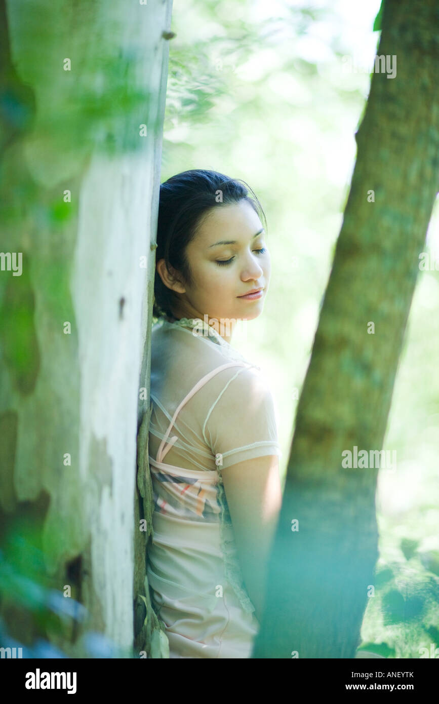Woman Sitting Against Tree Trunk High Resolution Stock Photography and ...
