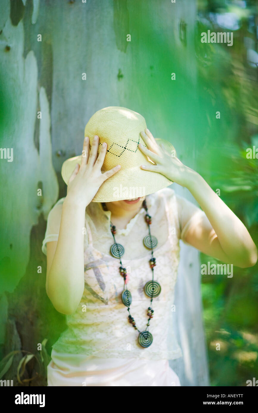 Woman pulling hat down to hide face hi-res stock photography and images ...