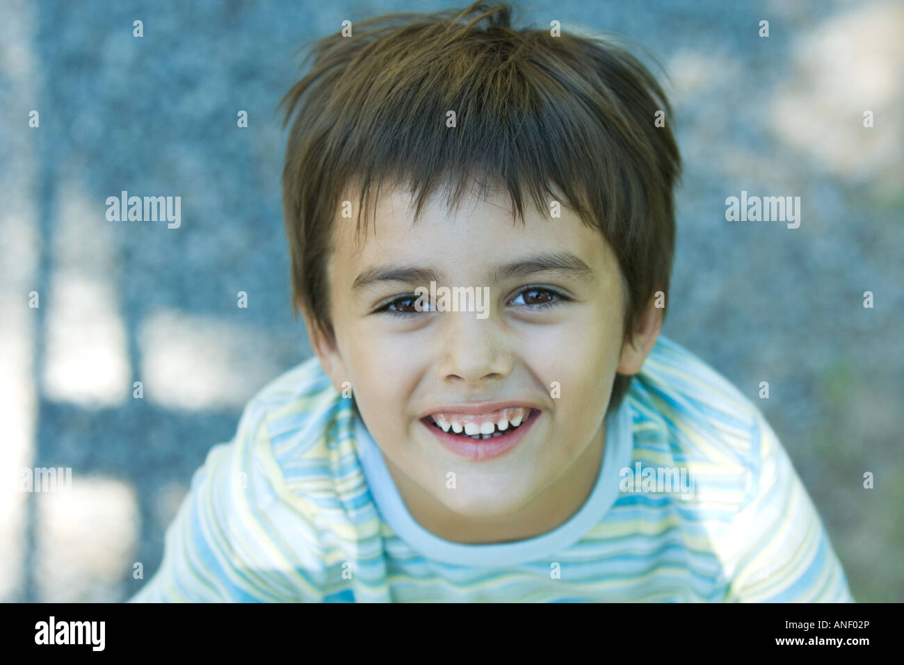 Boy smiling up at camera Stock Photo - Alamy