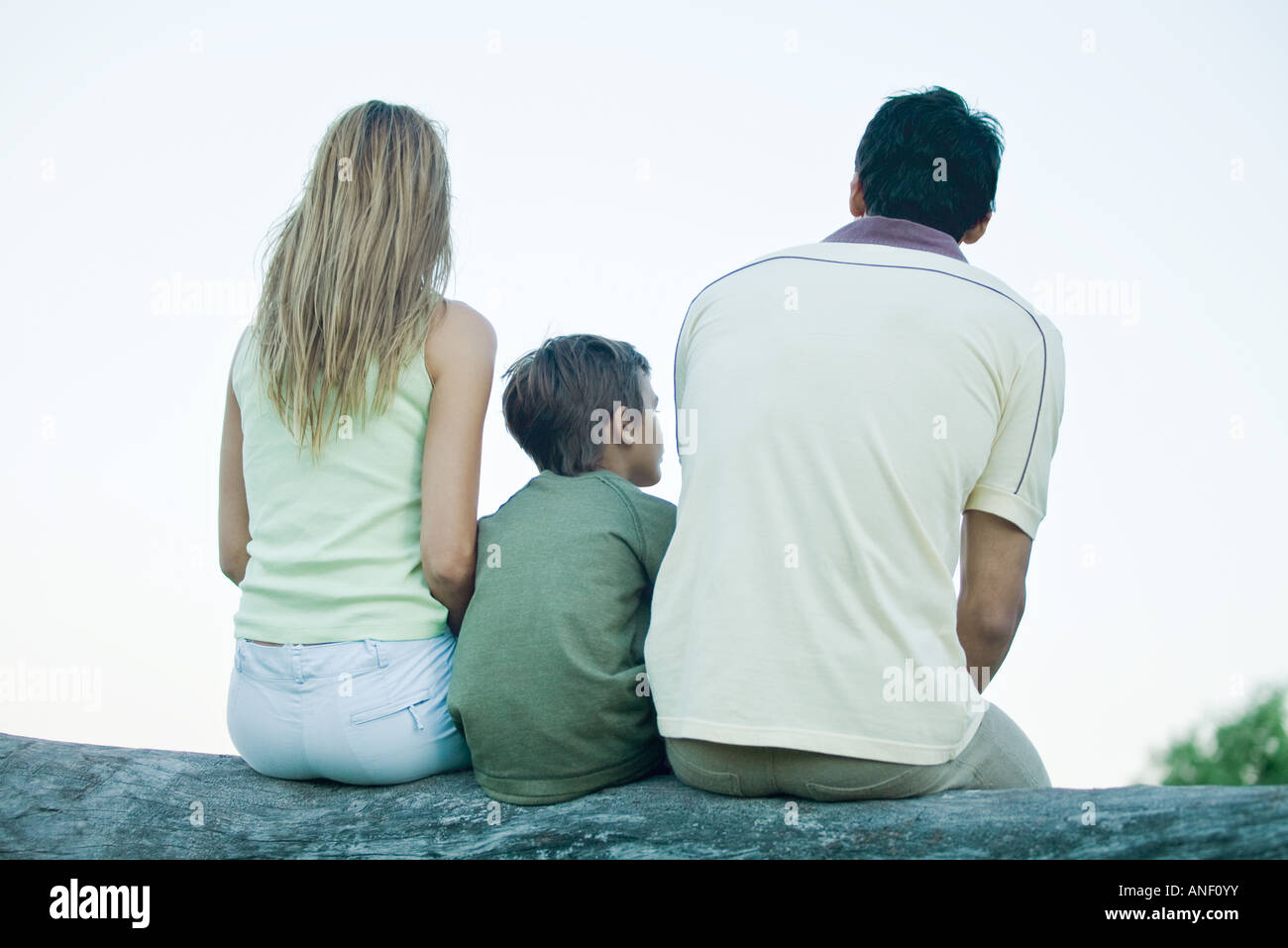 Boy sitting between parents hi-res stock photography and images - Alamy