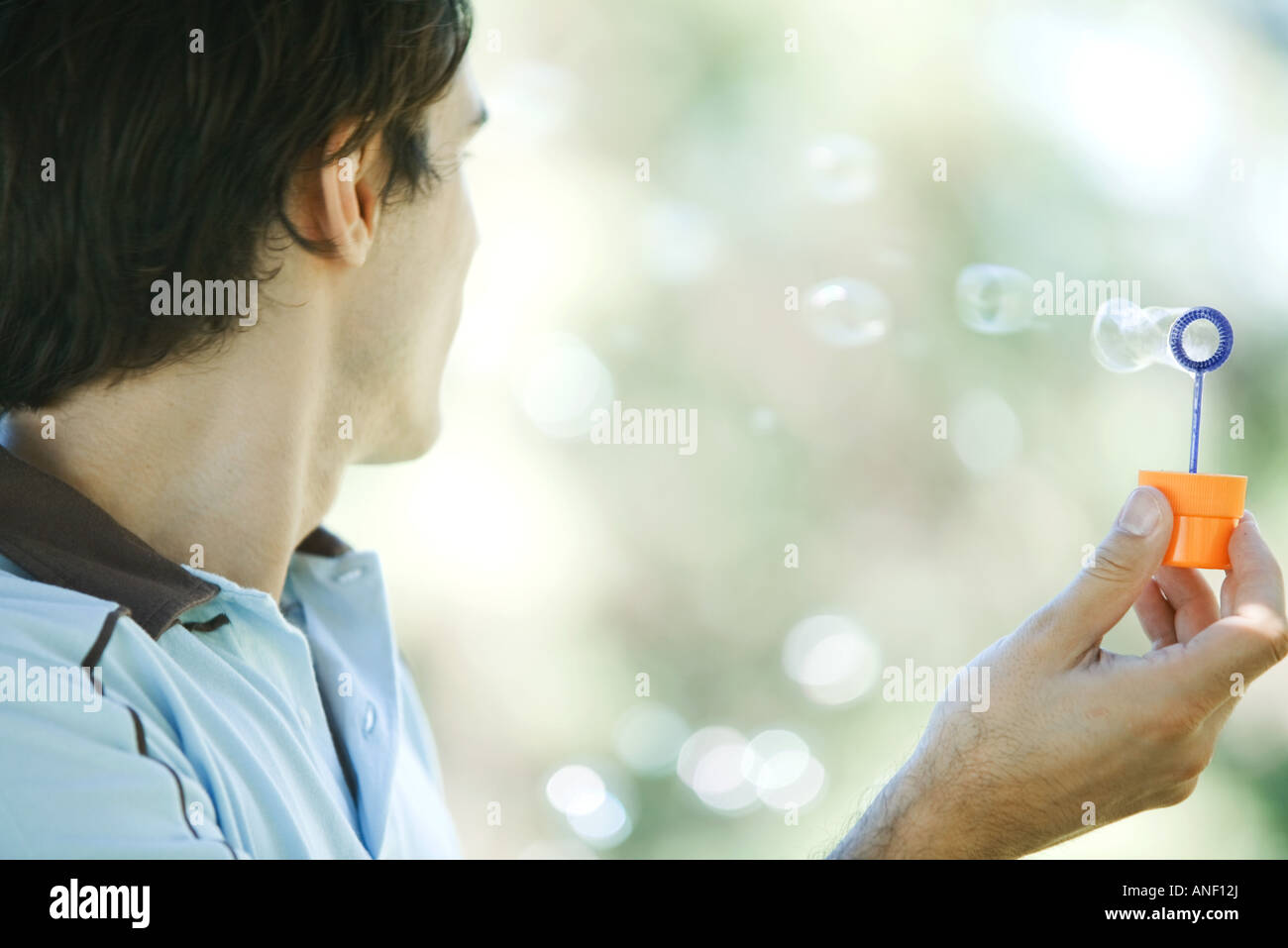Man blowing bubbles Stock Photo - Alamy