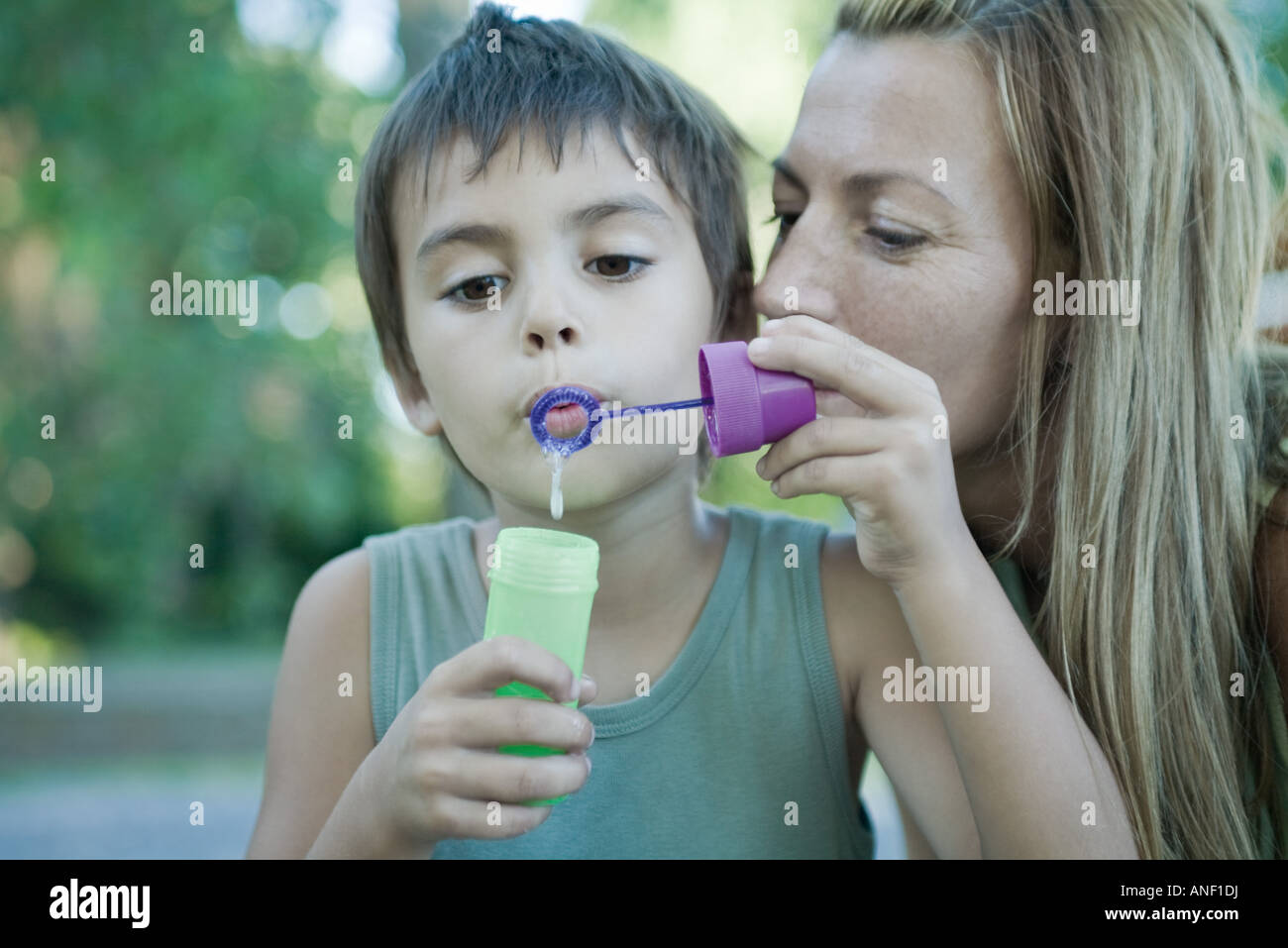 Mother and son blowing bubbles together Stock Photo - Alamy