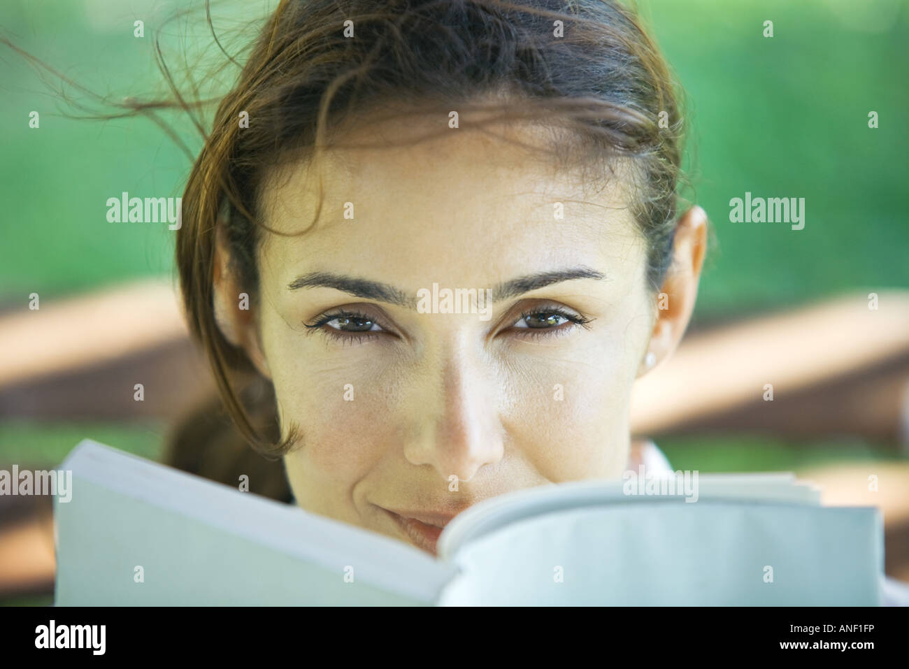 Woman looking over book, close-up Stock Photo - Alamy