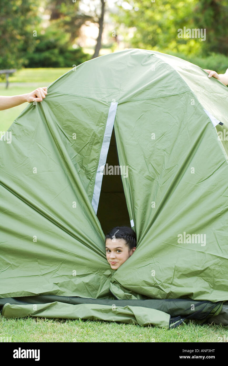 Young camper peeking head out of tent Stock Photo - Alamy