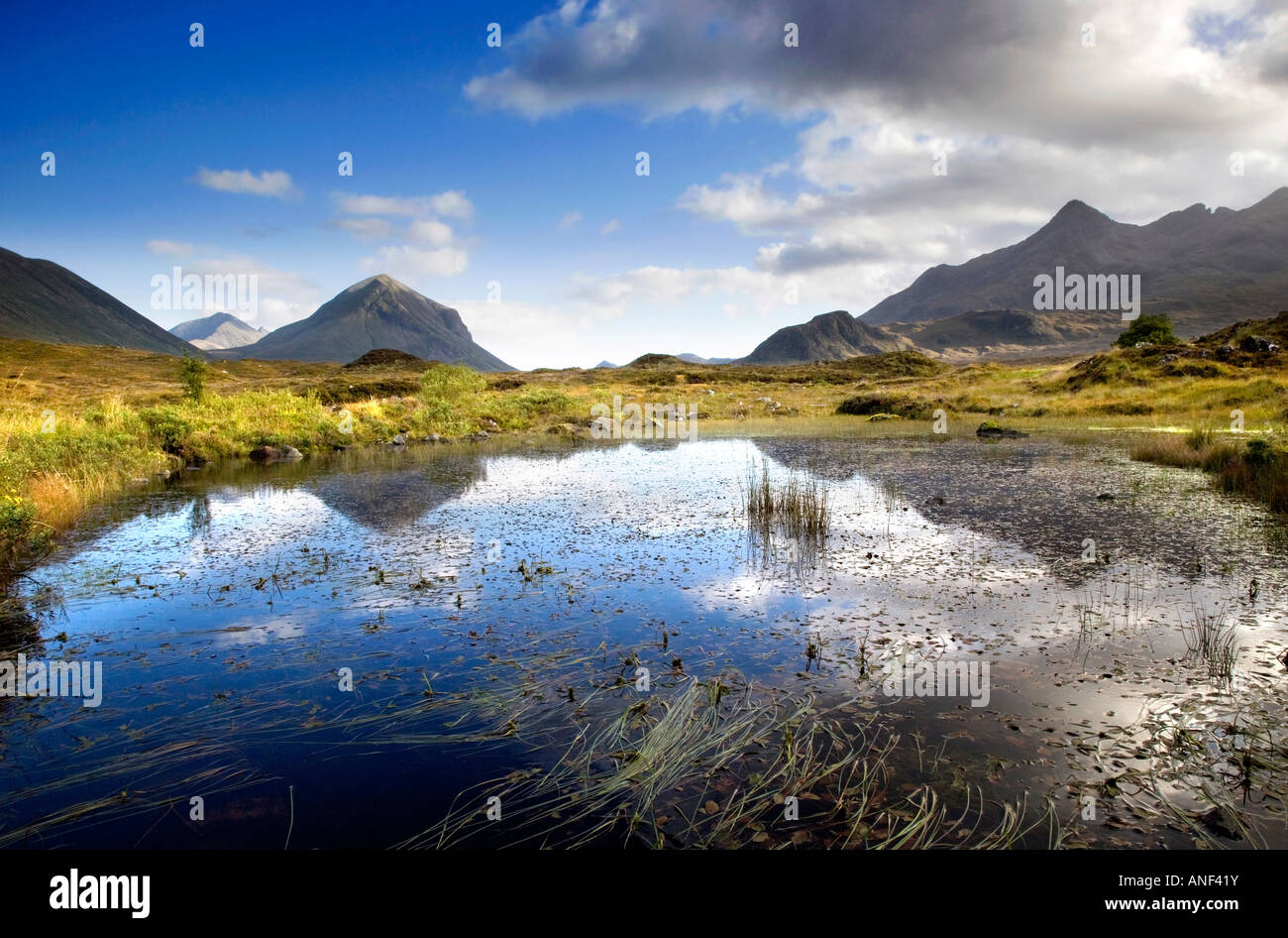 Scottish scene set on the Isle of Skye showing mountain tops grassland ...