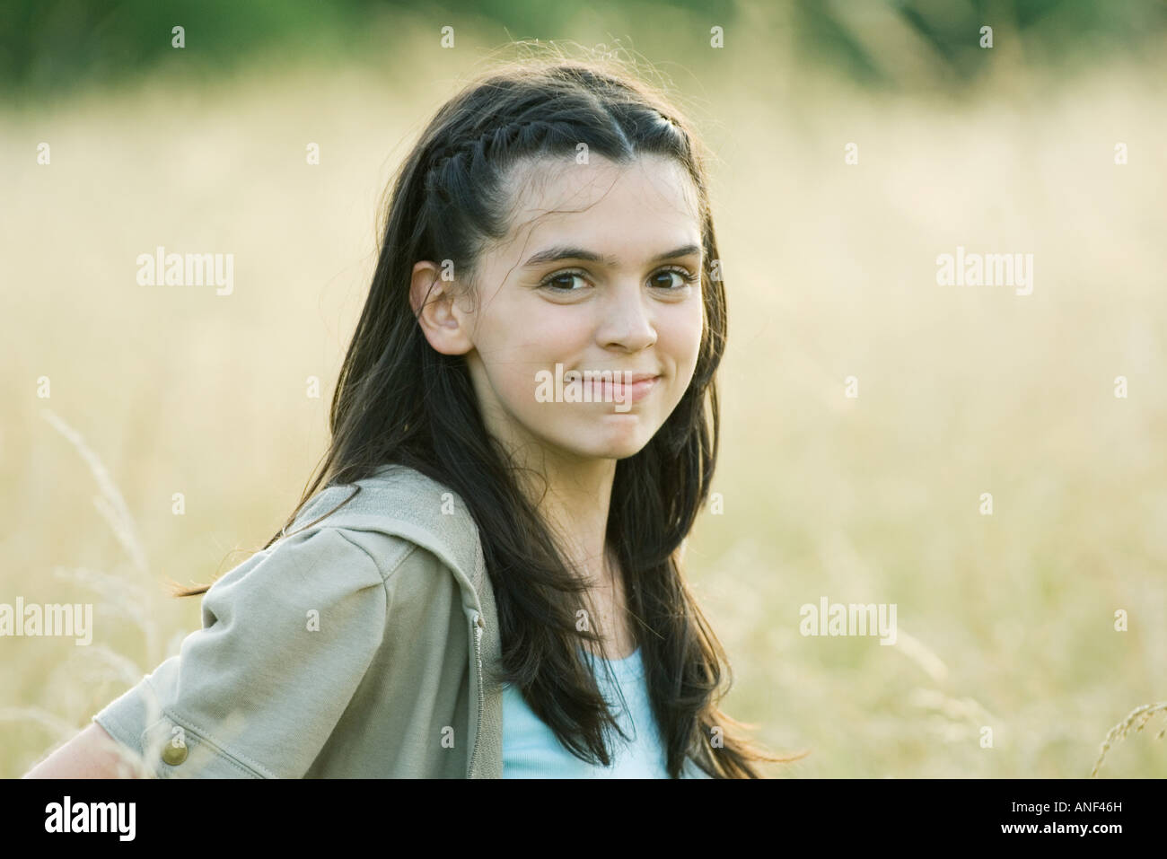 Teen girl in field, portrait Stock Photo - Alamy