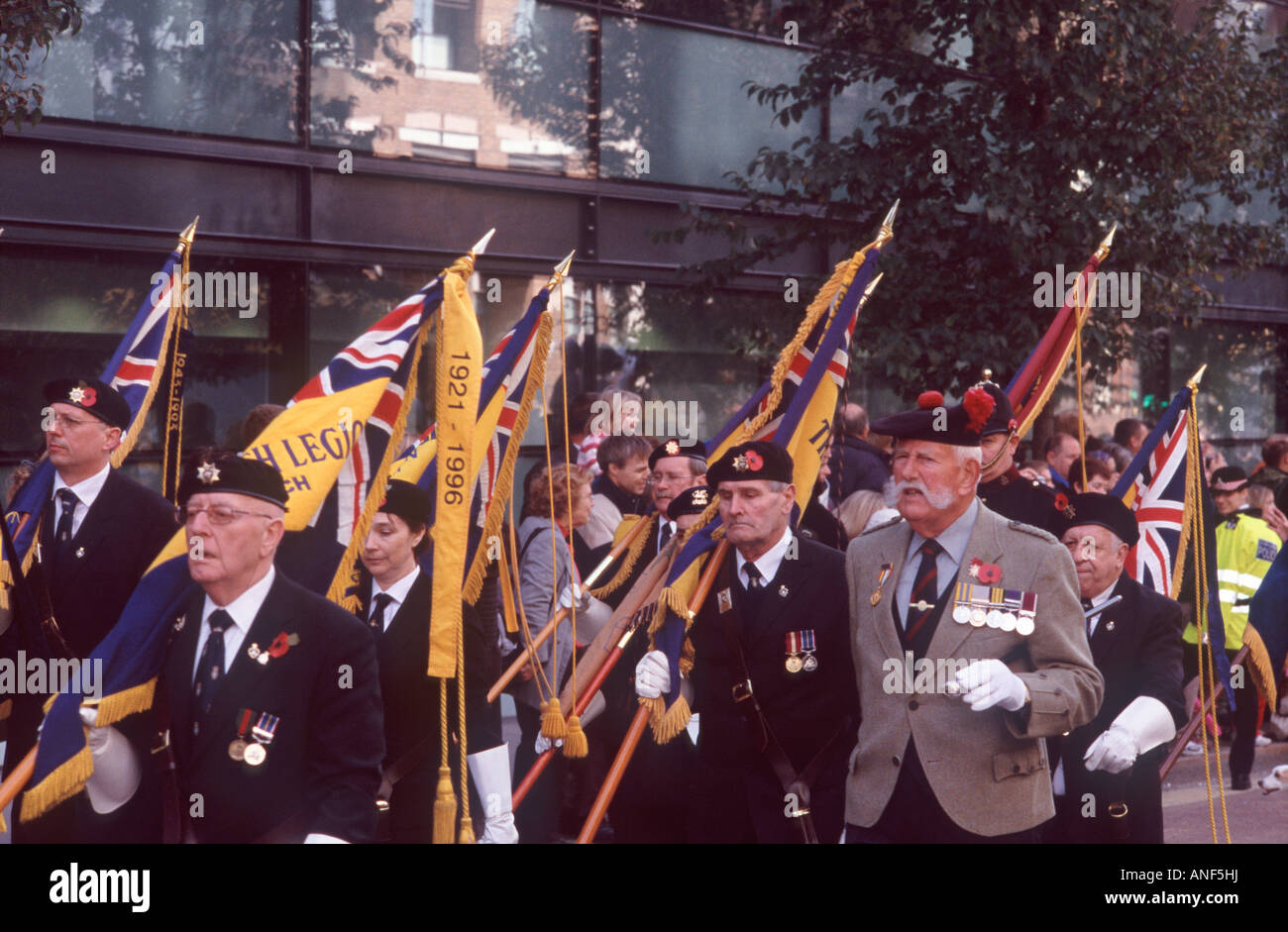 War veterans with medals and poppies from Royal British Legion marching ...