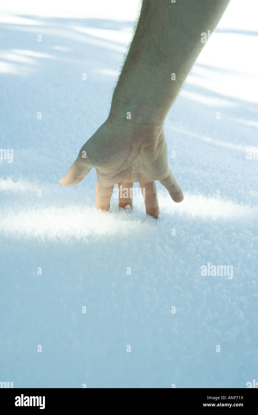 Man's hand touching snow Stock Photo - Alamy