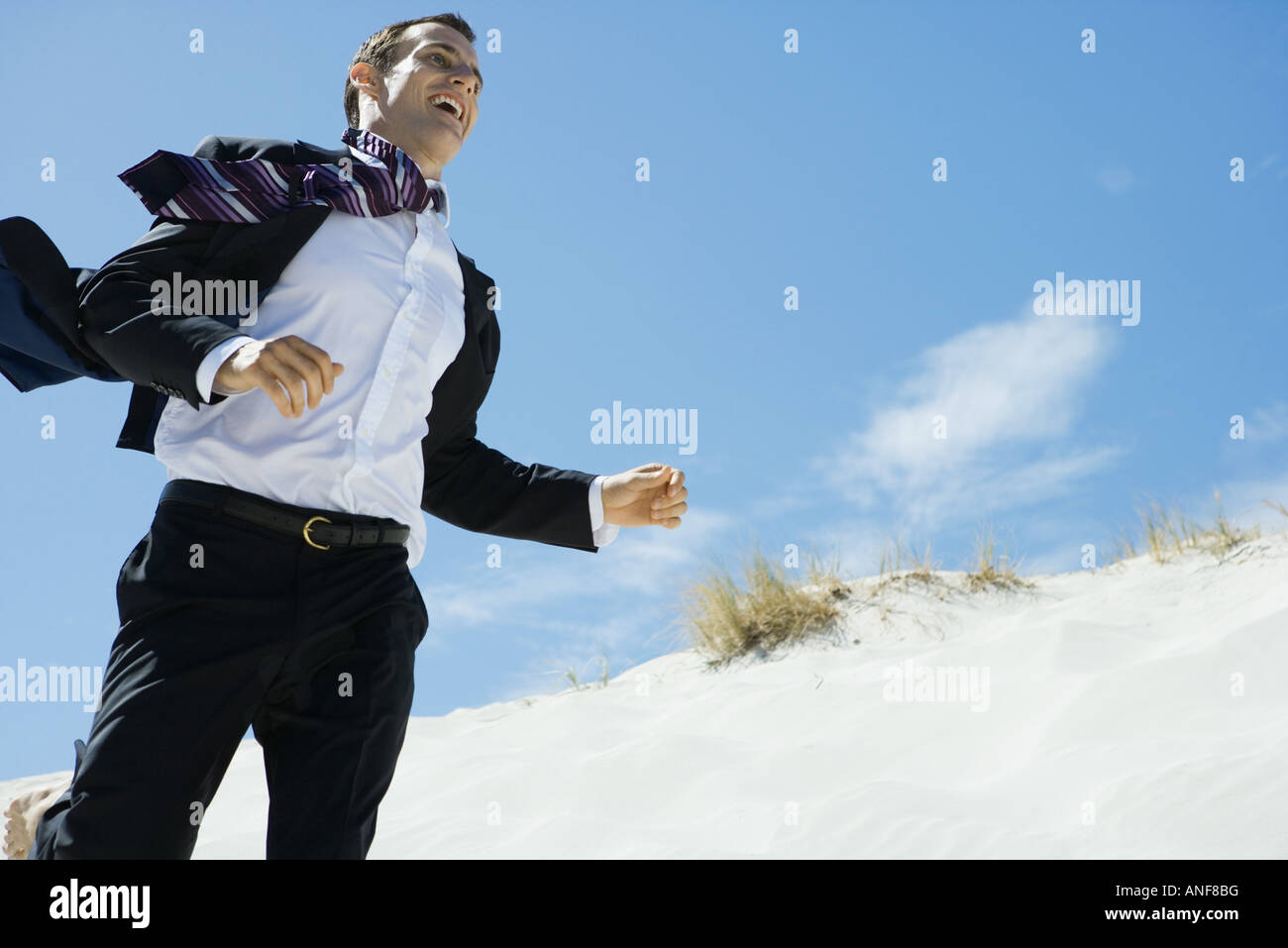 Man running across the sand hi-res stock photography and images - Alamy