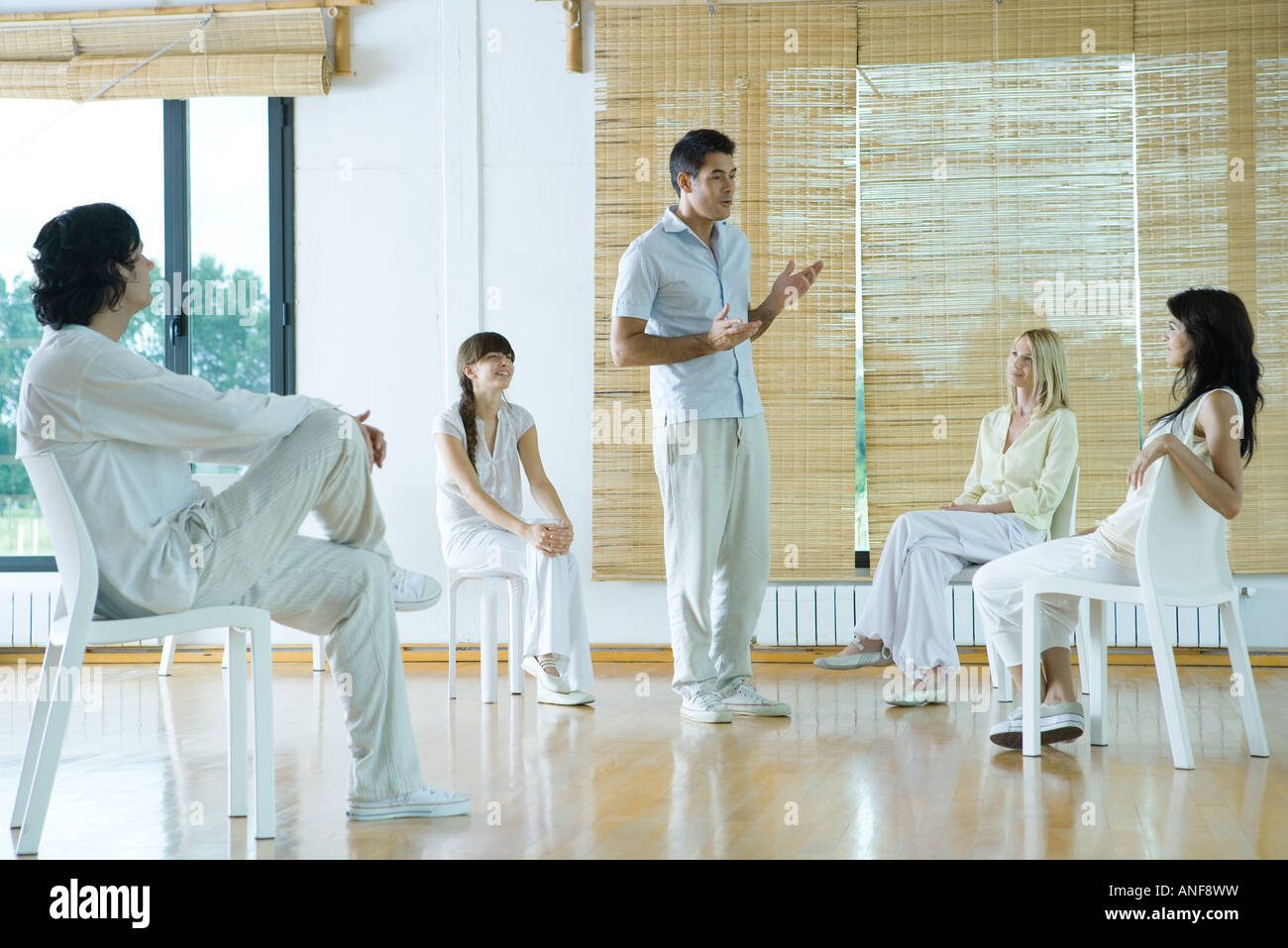 Man leading group therapy session Stock Photo - Alamy