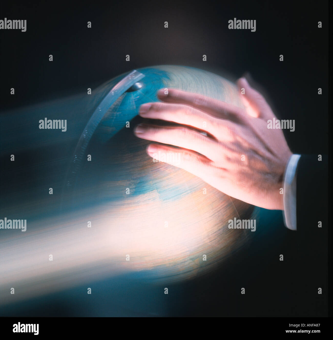 hand turning a globe Stock Photo - Alamy