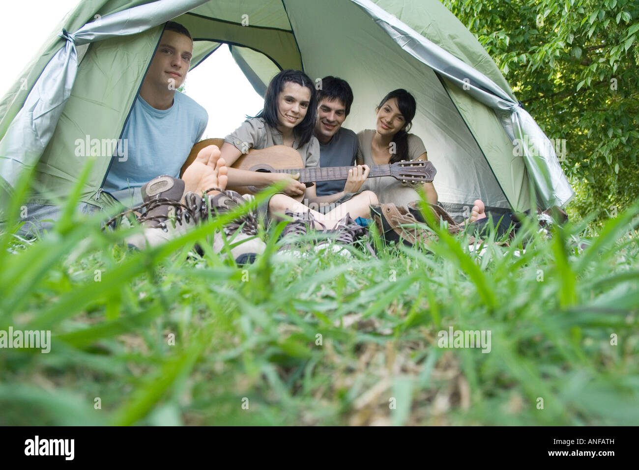 Friends sitting in tent together Stock Photo - Alamy