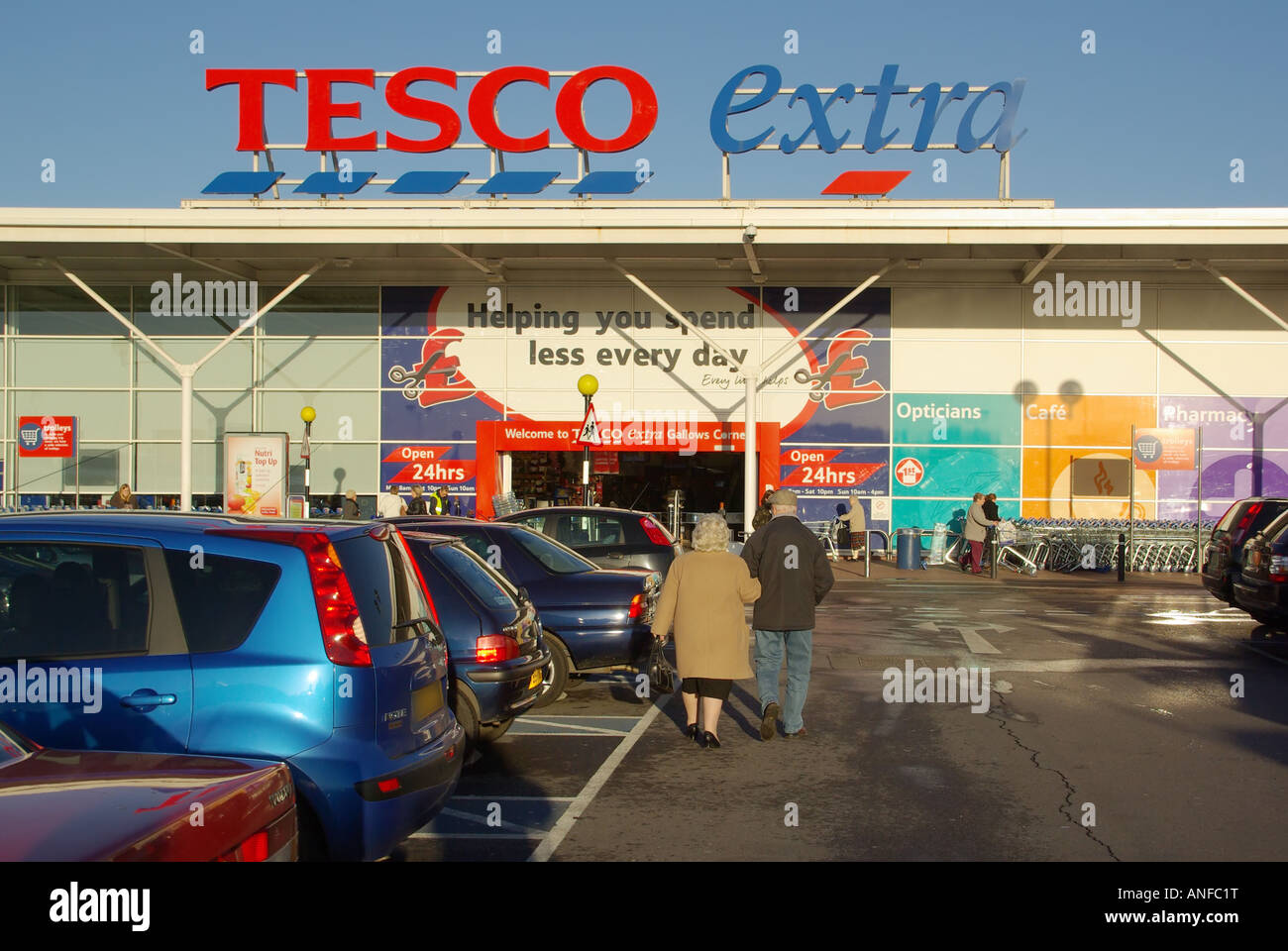 Tesco Extra supermarket store wintertime view elderly couple walking ...