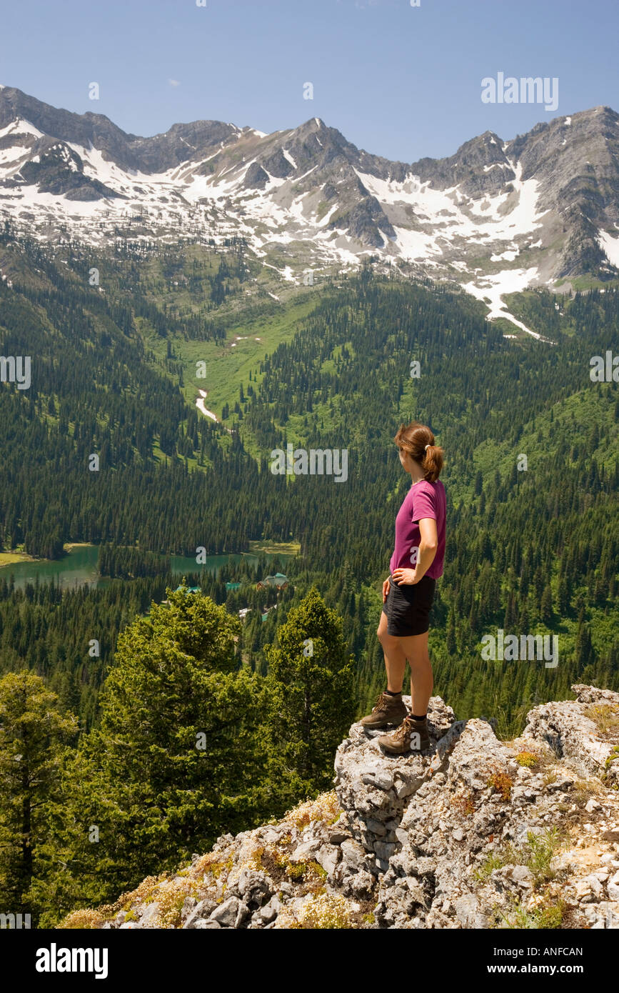 Young woman enjoys view of Island Lake and Lizard Range while hiking at ...