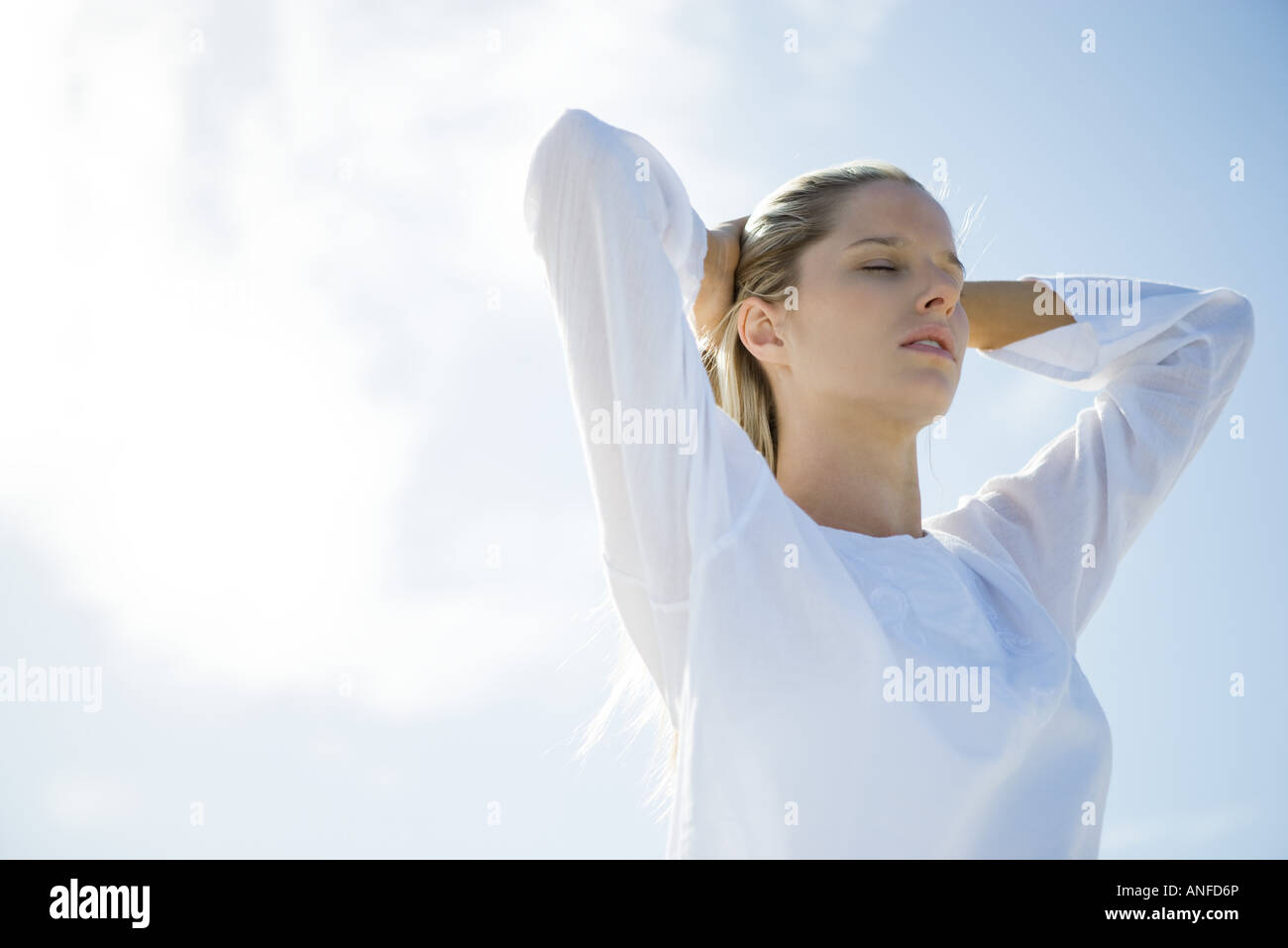 Woman pushing hair back outdoors hi-res stock photography and images ...