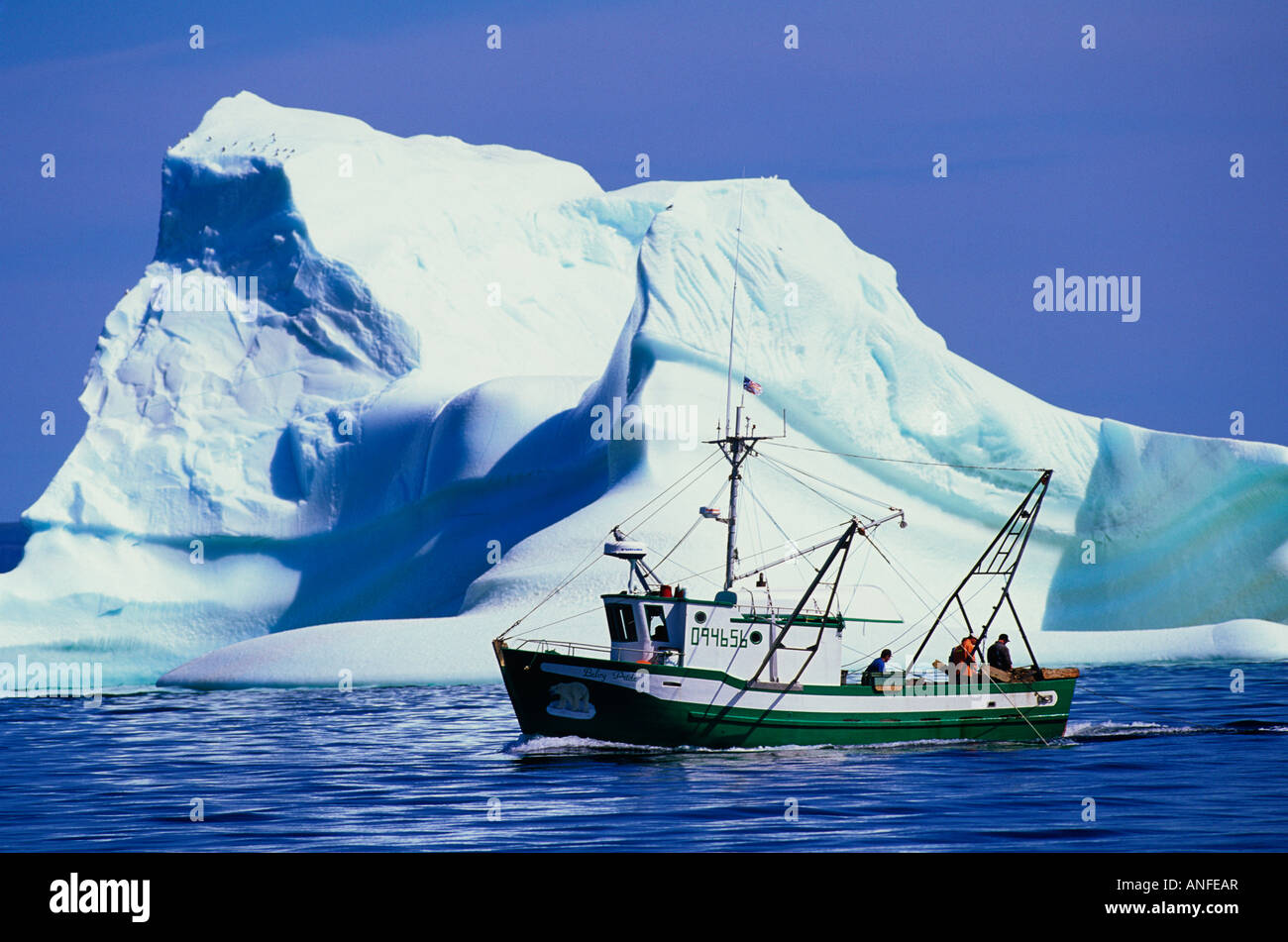 Iceberg and fishing boat, Grey Islands, Newfoundland, Canada Stock ...