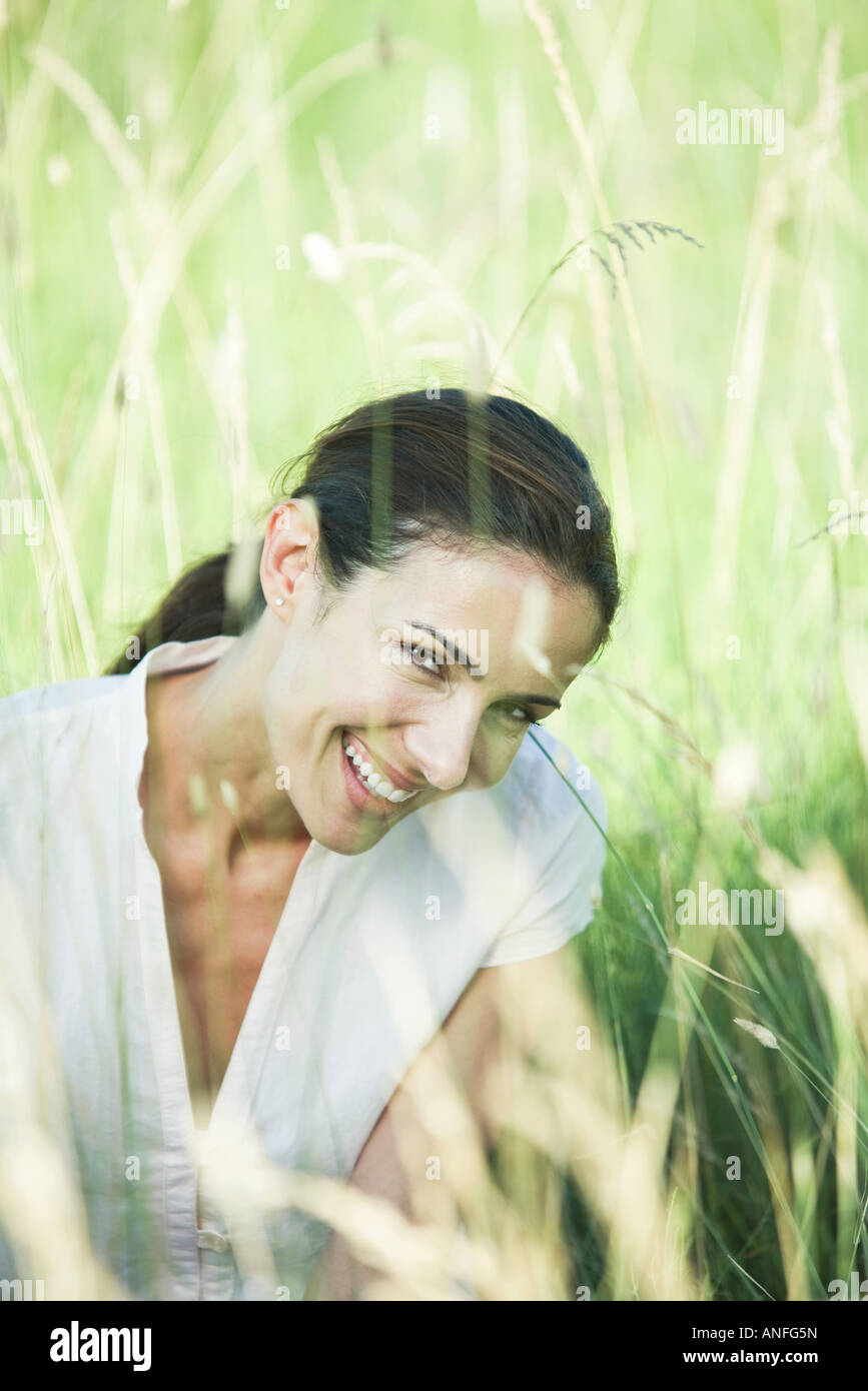 Woman in field, smiling at camera, portrait Stock Photo - Alamy