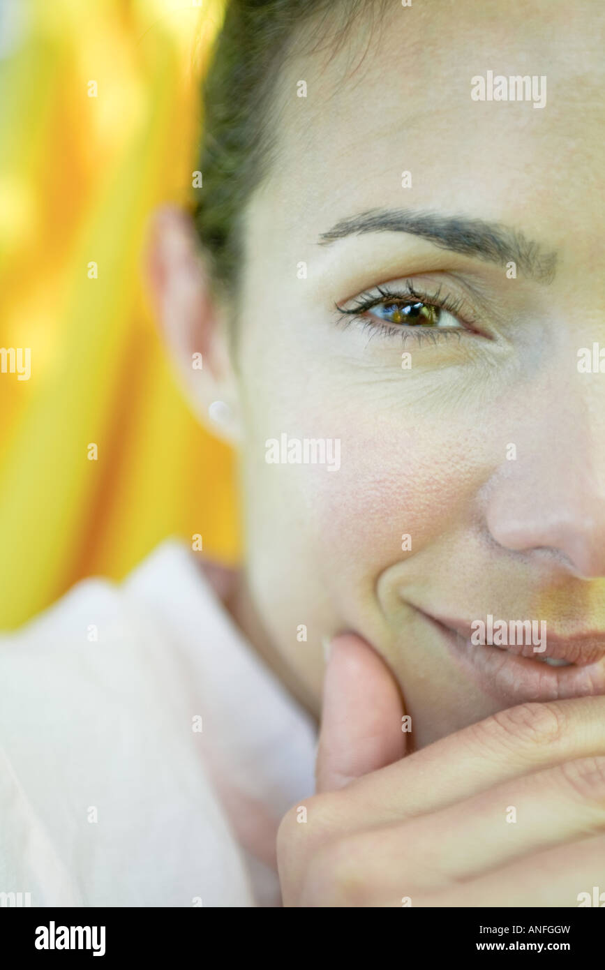 Woman's face and hand, looking at camera, close-up, cropped Stock Photo ...
