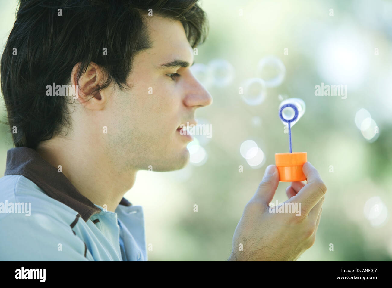 Man blowing bubbles Stock Photo - Alamy