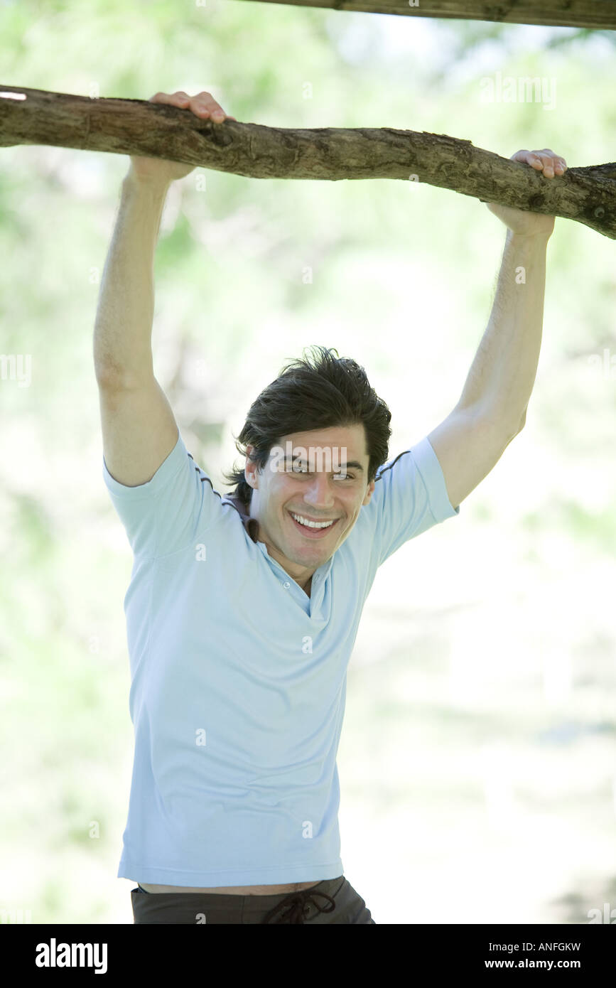 Man holding onto branch of tree hi-res stock photography and images - Alamy