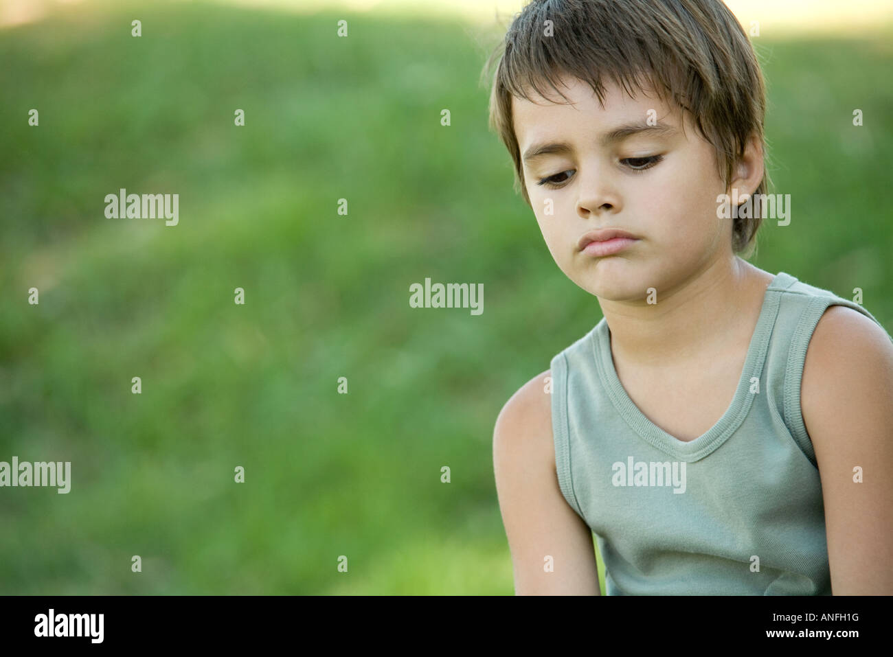 Little boy outdoors, looking down Stock Photo - Alamy
