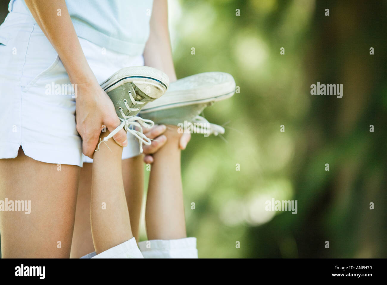 Mother and son, woman holding boy's feet upside down, cropped Stock ...