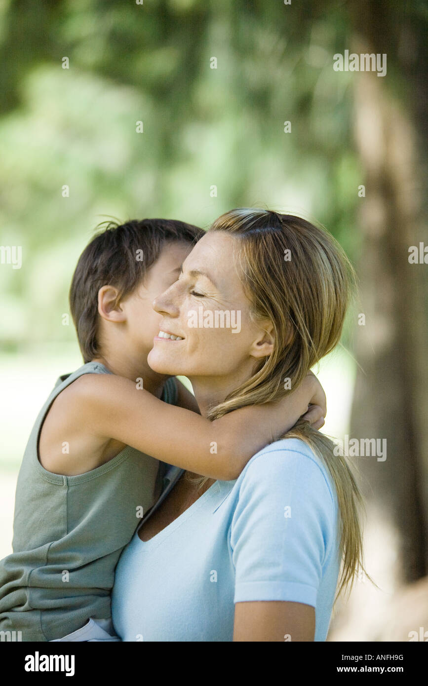Mother and son hugging, side view Stock Photo - Alamy