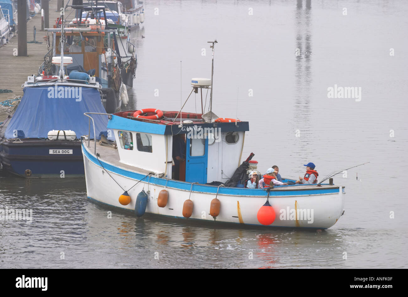 Boat setting out on a fishing trip on the River Medway Kent England ...