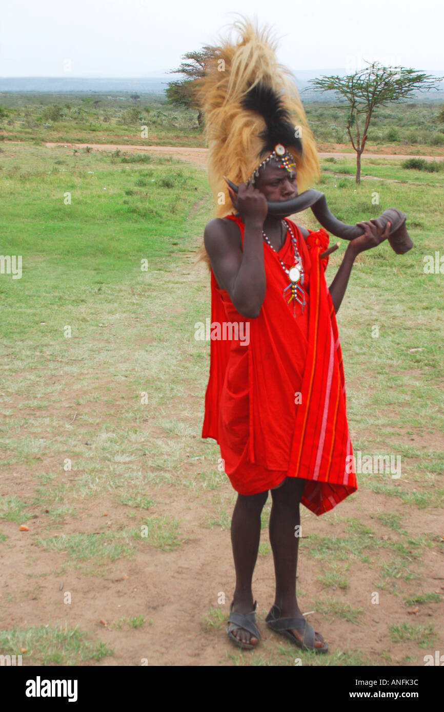 Maasai warrior and chief of tribal village wearing lion mane head-dress ...
