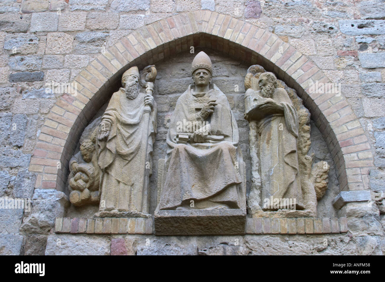 Sculpture on the wall of a church in Volterra Tuscany Italy Stock Photo ...